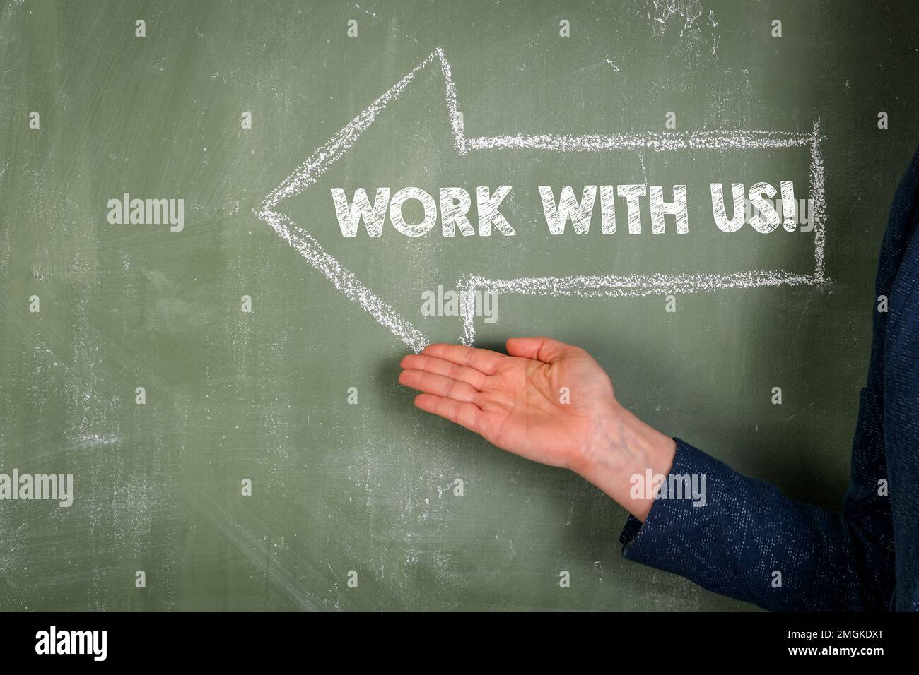 Work with us. Text and white pointing arrow on green chalkboard Stock ...