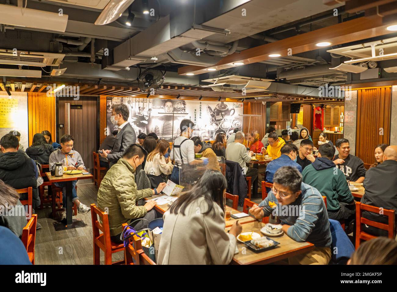 Hong Kong - December 2022 - Inside a dim sum restaurant, people eating ...