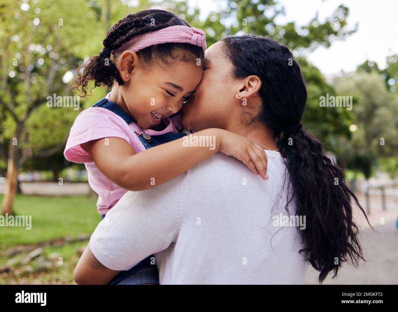 Mother Daughter And Kiss In A Park Love And Sweet While Bonding