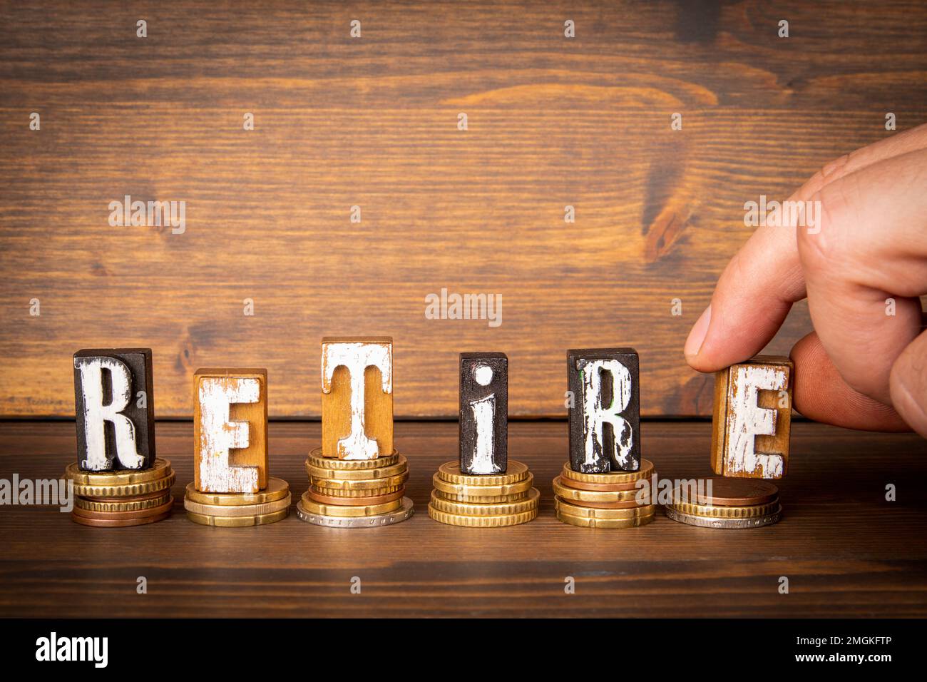 Retire Concept. Alphabet blocks and change on wooden background Stock ...