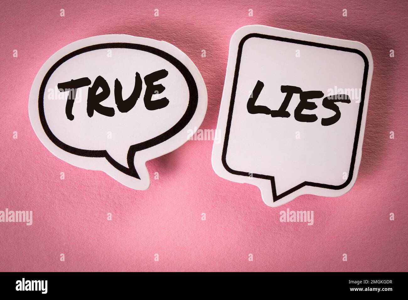 True and Lies concept. White speech bubbles with text on a pink ...