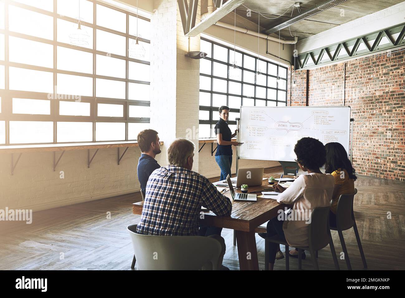 Office meeting time. a group of colleagues having an office meeting ...