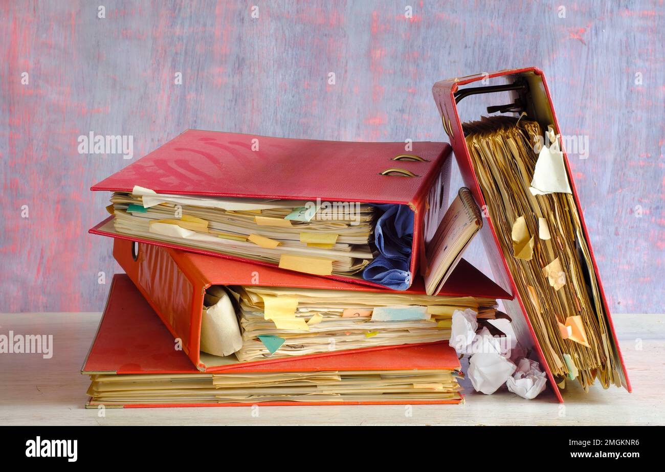 stack of dusty messy file folders,red tape, bureaucracy,aministration ...
