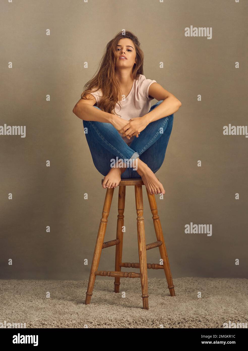 Shes something special. Studio shot of a beautiful young woman sitting ...