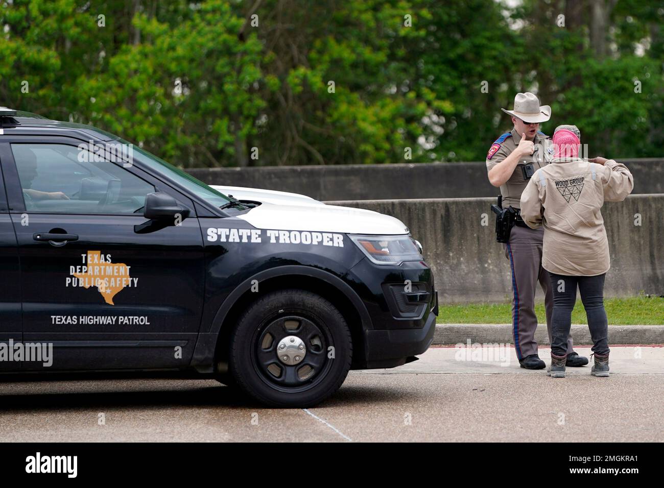 A woman talks with a Texas Department of Public Safety State Trooper at ...