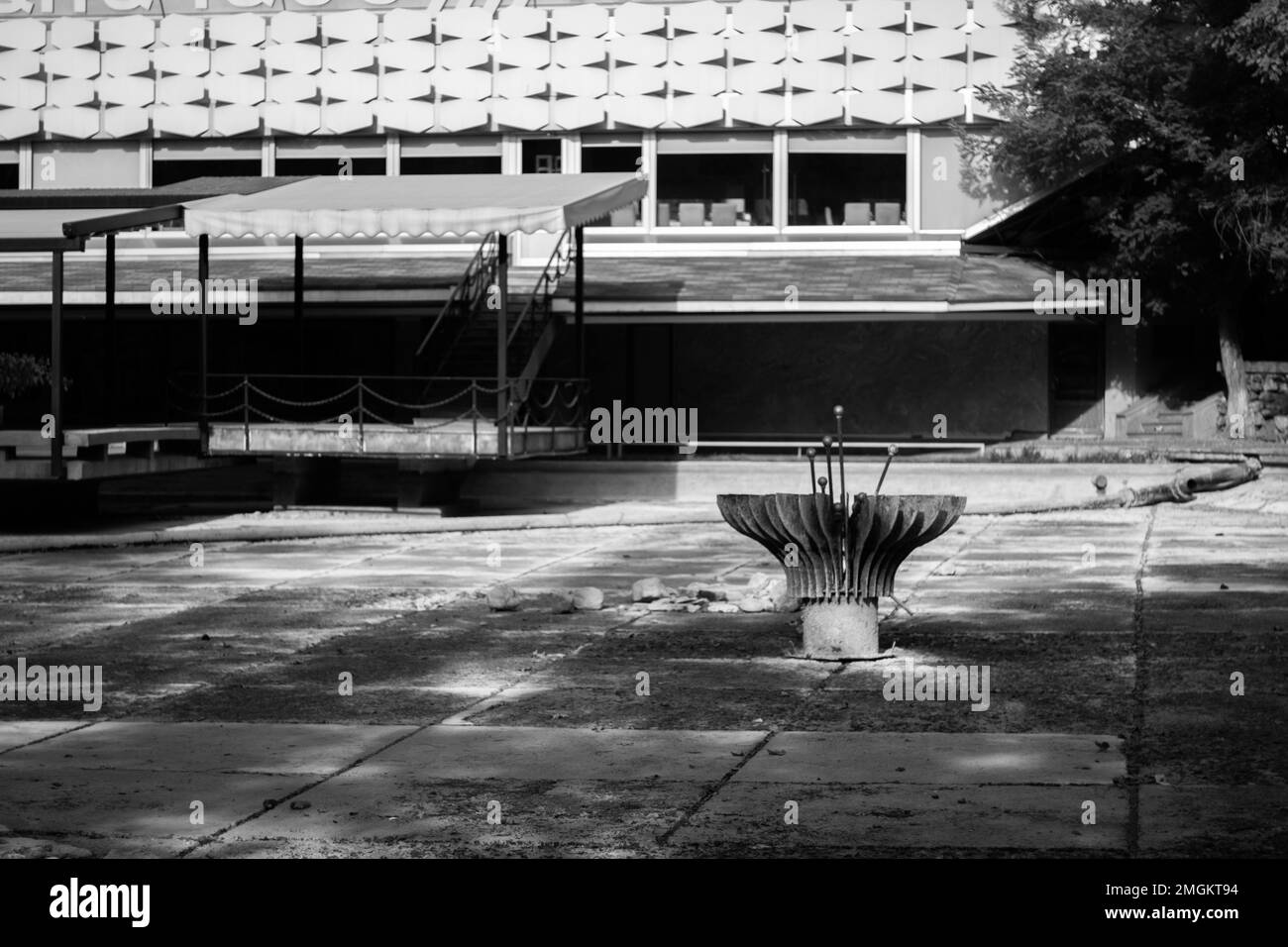 drained pool in Yerevan's circular park in front of a cafe. black and ...