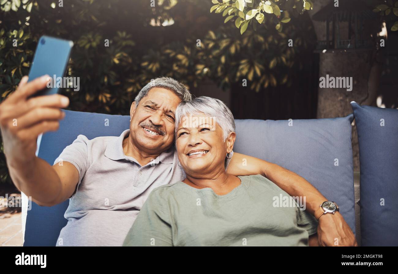 Relax, smile and senior couple with a selfie on an outdoor couch during ...