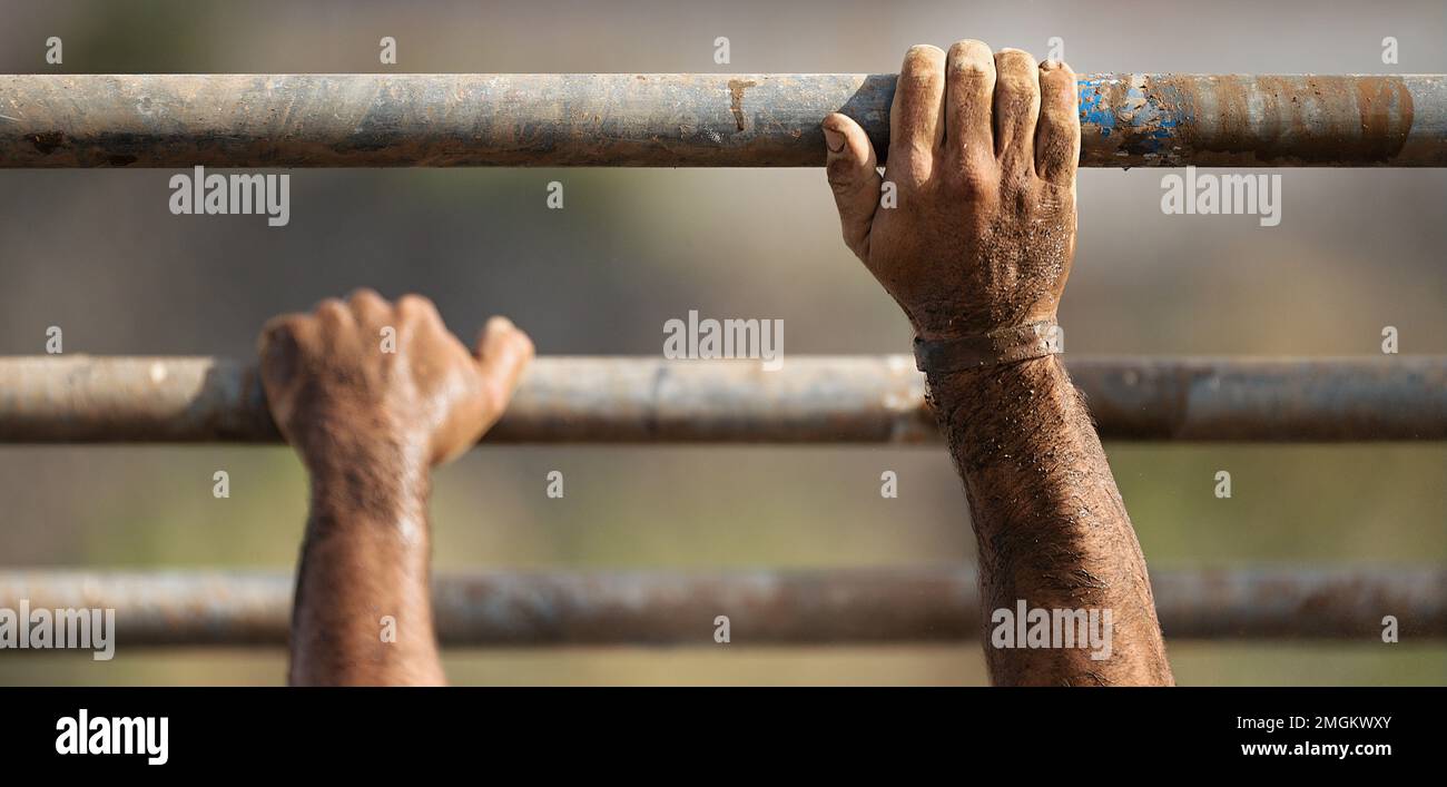 Mud race running over obstacles race runners, hands overcome obstacle ...