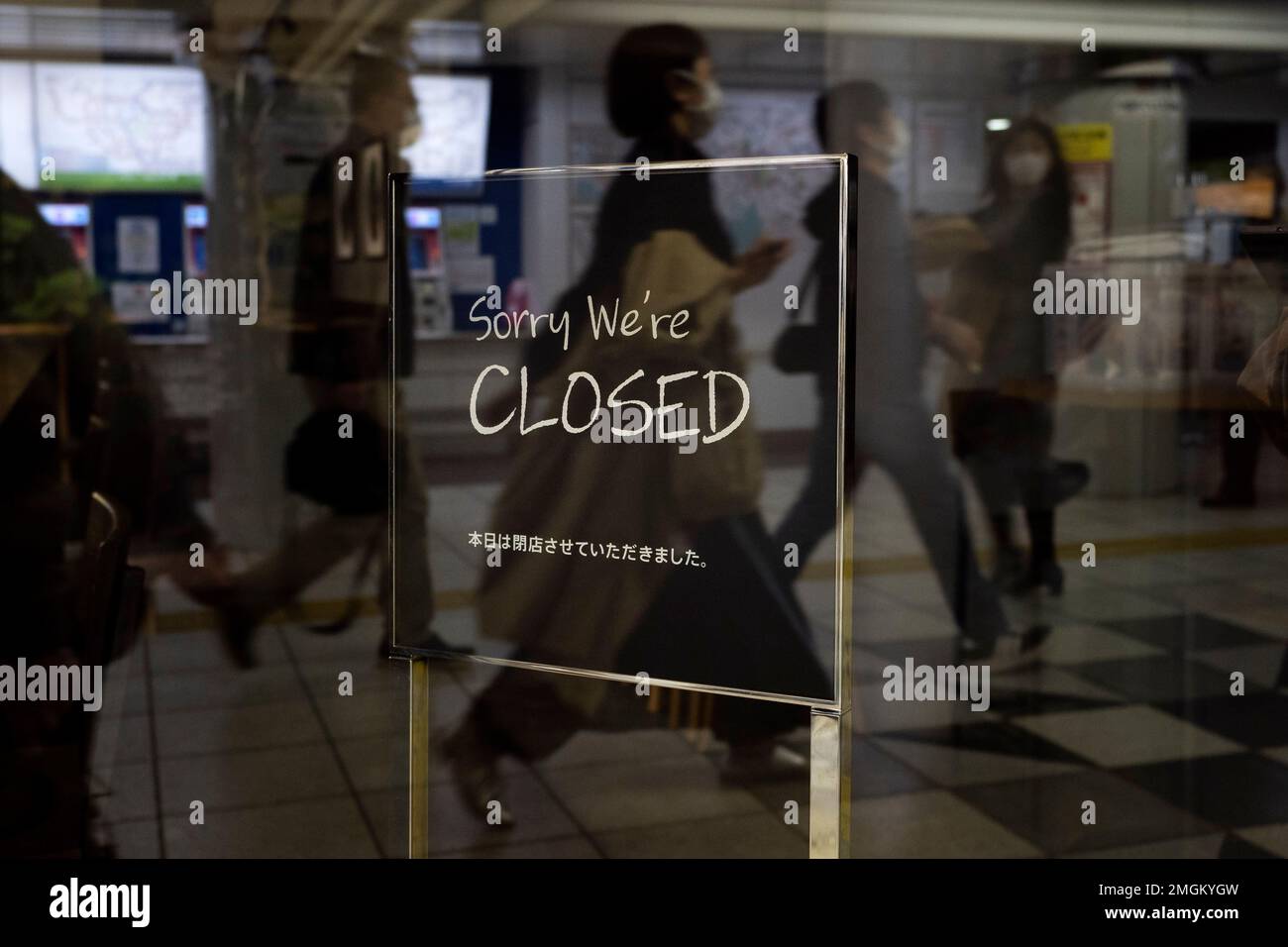 A closed sign is seen through the door of a Starbuck coffee shop ...