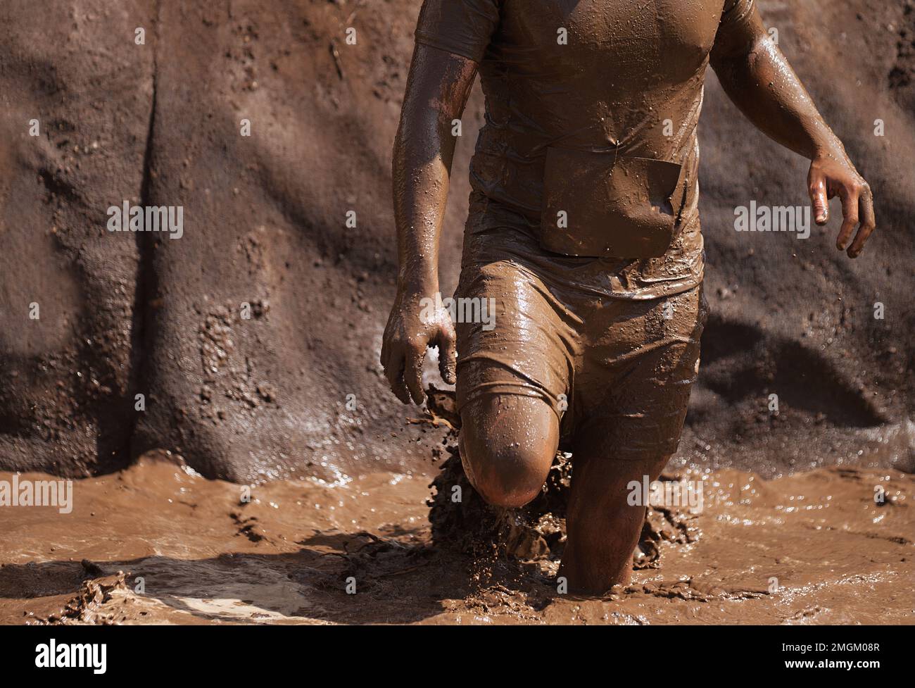 Mud race runners,during extreme obstacle races Stock Photo - Alamy