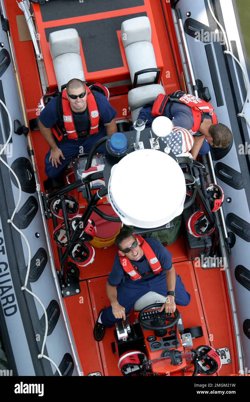 Boarding Loading Operations - 26-HK-69-4. close-up aerial view of CG crew aboard RHI boat--dated ...