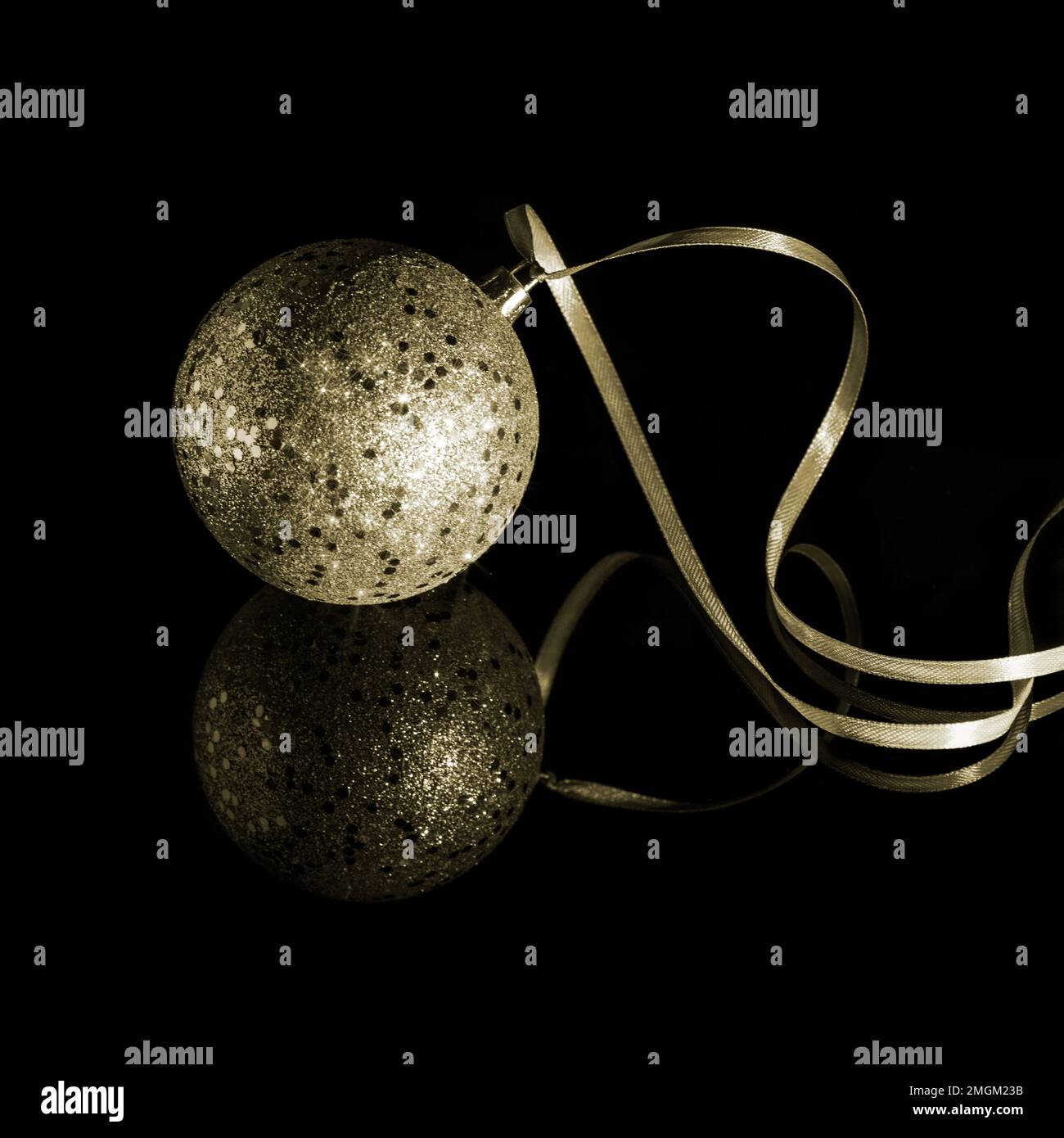 Gold bauble and ribbon on black background with refection Stock Photo ...