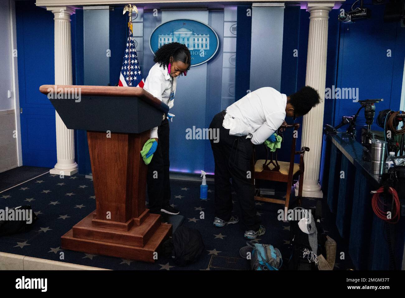 Workers clean the lectern in the White House briefing room ahead the ...