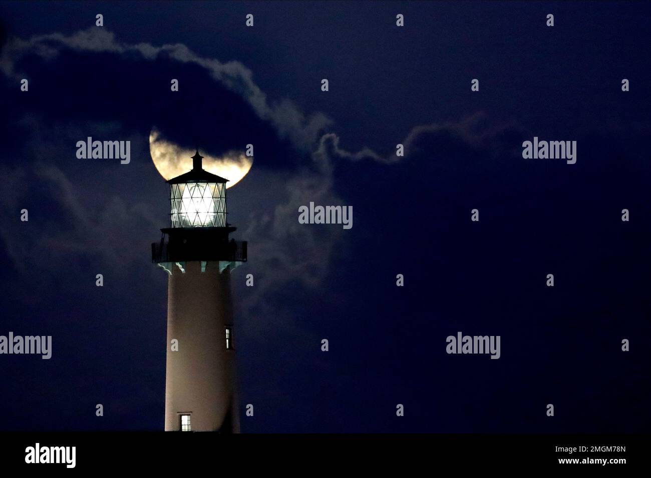 Clouds are seen over the Jupiter Lighthouse during the first Supermoon ...