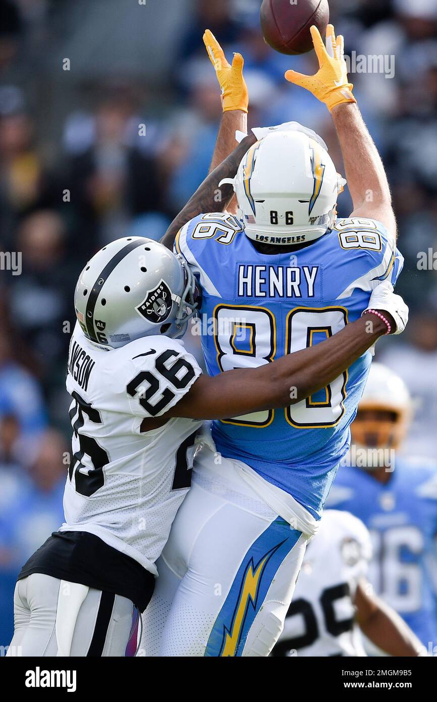 Oakland Raiders cornerback Nevin Lawson breaks up a pass intended for ...