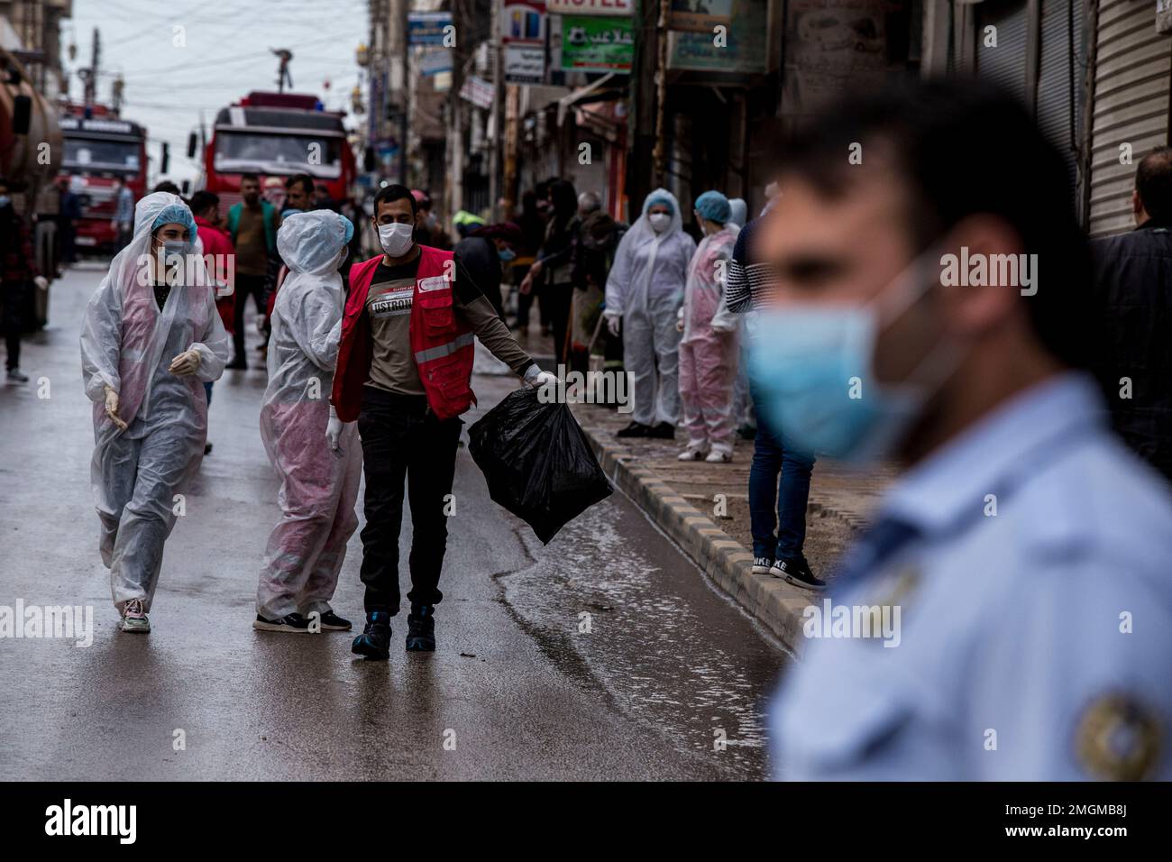 Medical workers oversee the disinfection of the streets to prevent the ...