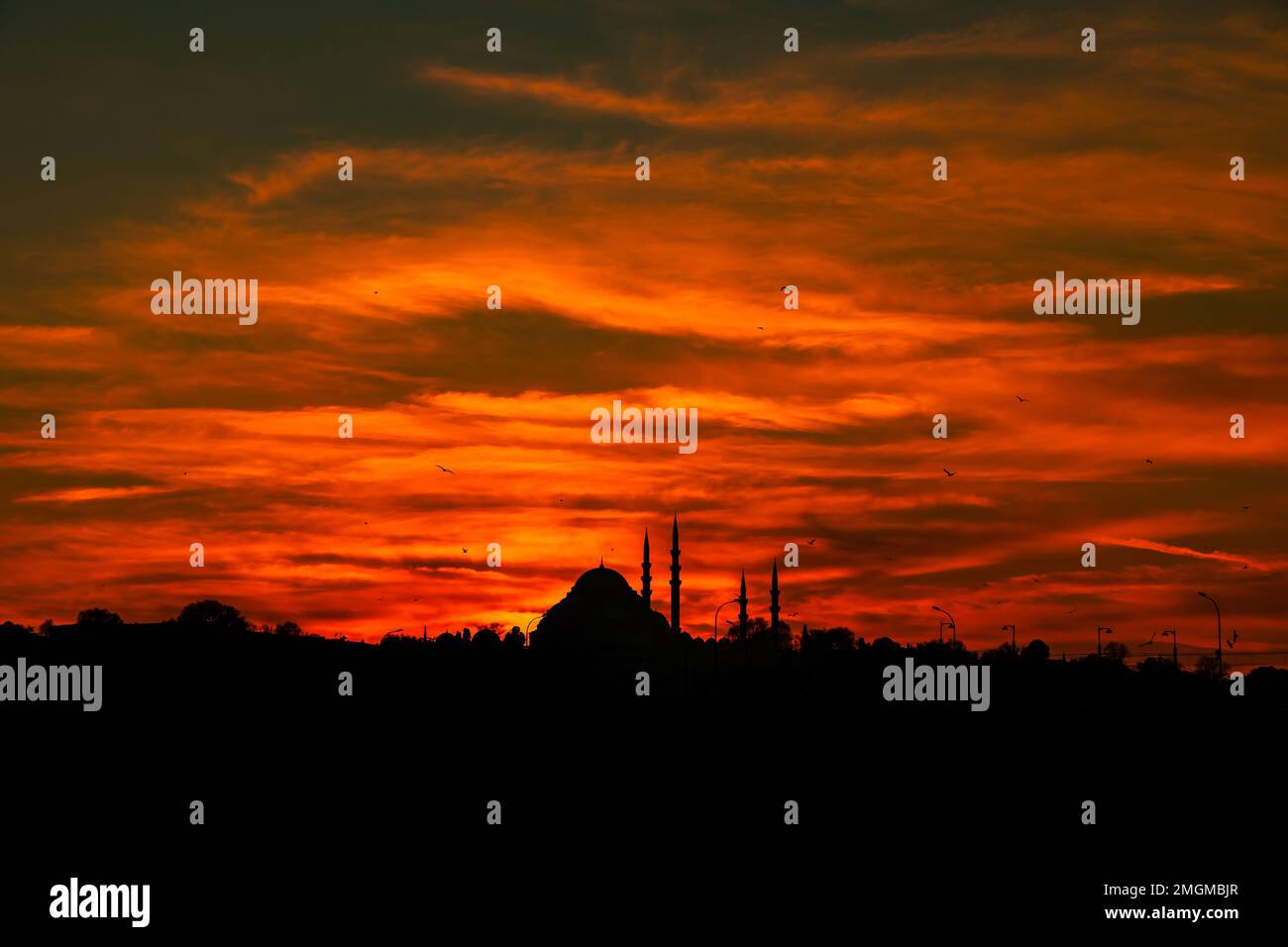Istanbul at sunset with dramatic orange and red clouds. Silhouette of ...