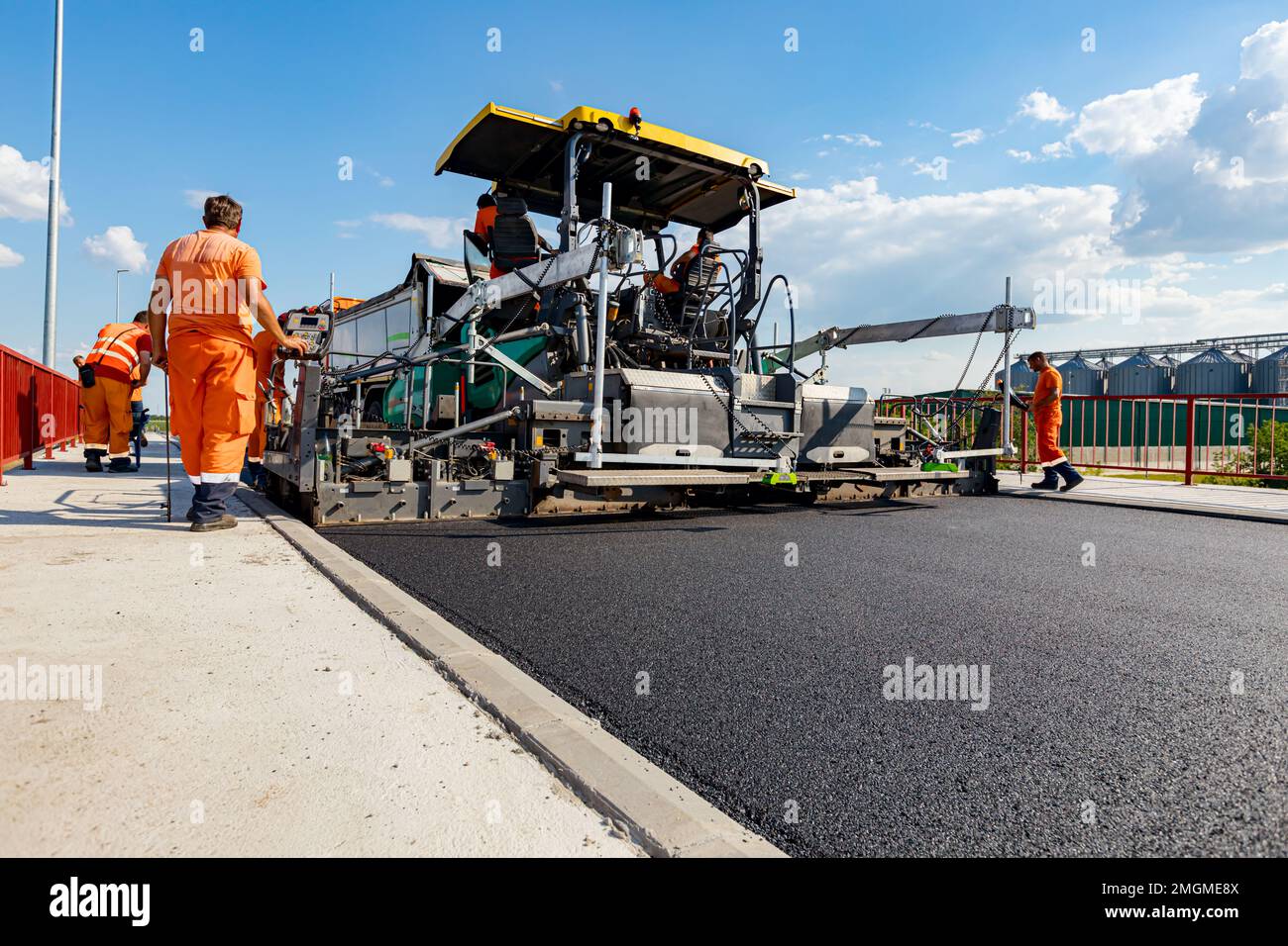 View on machine for laying asphalt, spreading layer of hot tarmac on ...