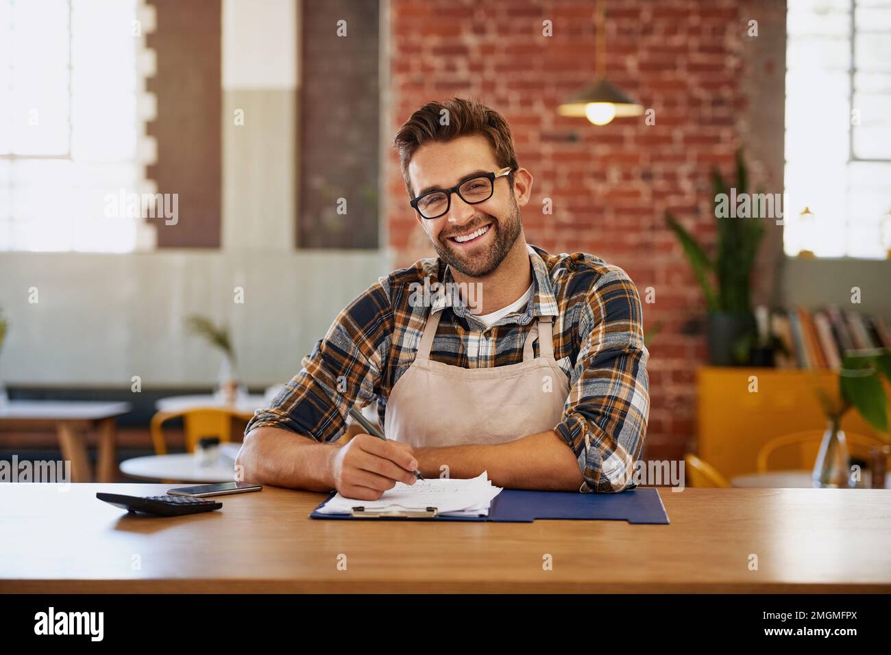 I keep my business running smoothly. Portrait of a happy young business ...