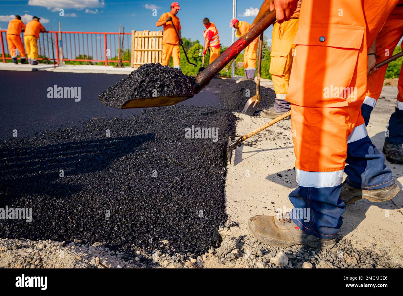 Workers pouring hot asphalt shovels hi-res stock photography and images ...