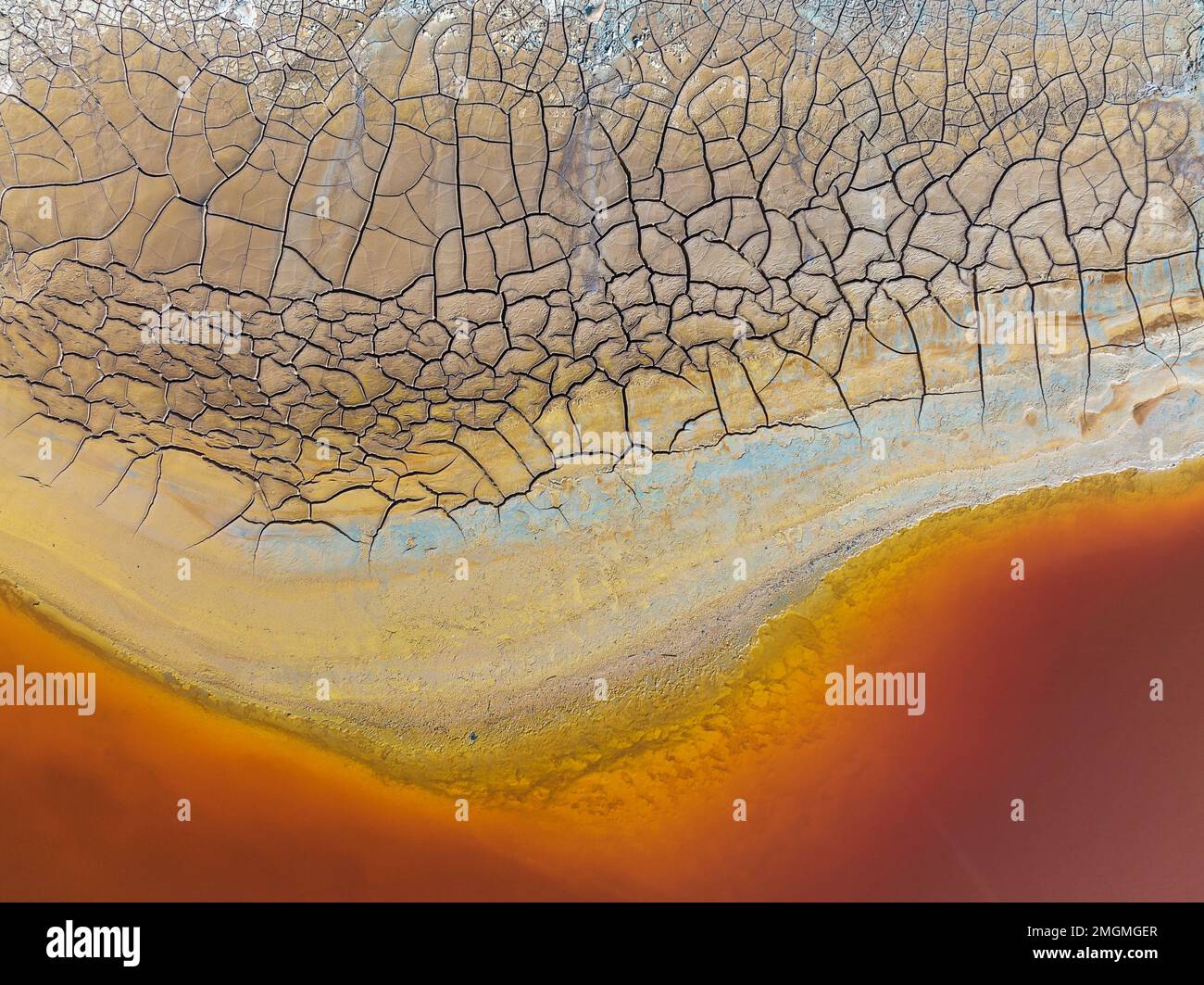 Cracked earth at the bank of the Rio Tinto (Red river) with its deep ...
