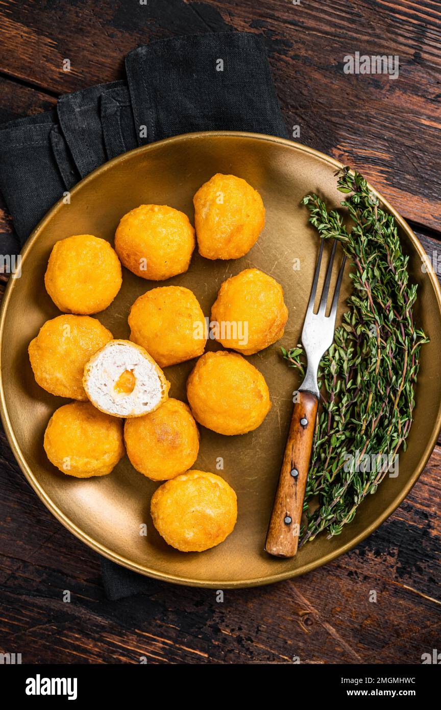 Fried crispy round chicken nuggets with Cheese. Wooden background. Top ...