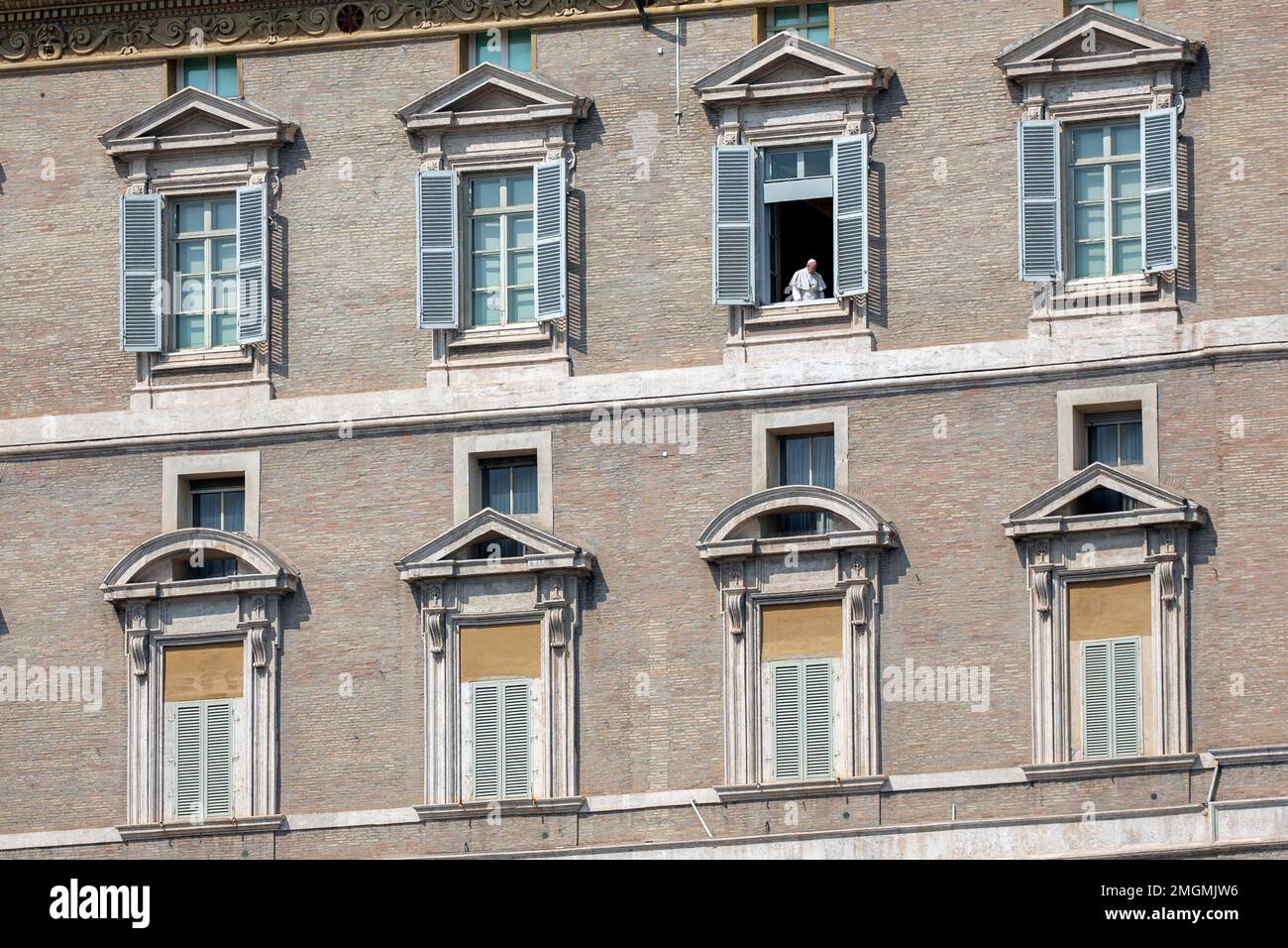 Pope Francis leans out of the window of his private library overlooking ...