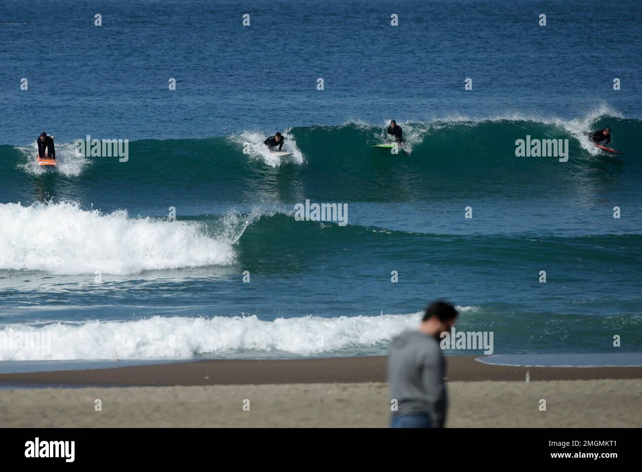 Surfers ride a wave at Ocean Beach in San Francisco, Saturday, March 21 ...