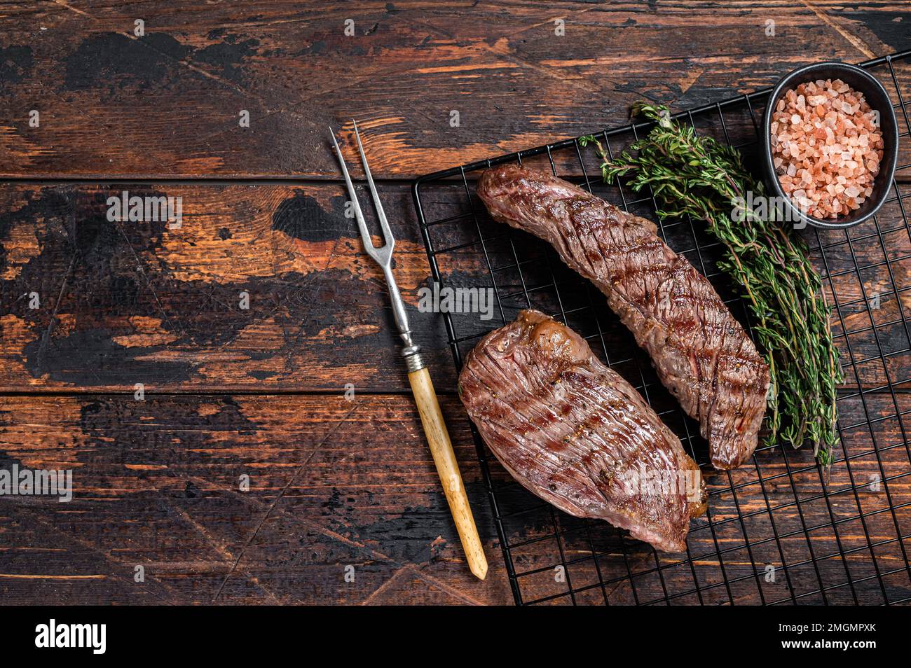 Grilled Sirloin flap or Bavette beef meat steak on a griil with herbs ...