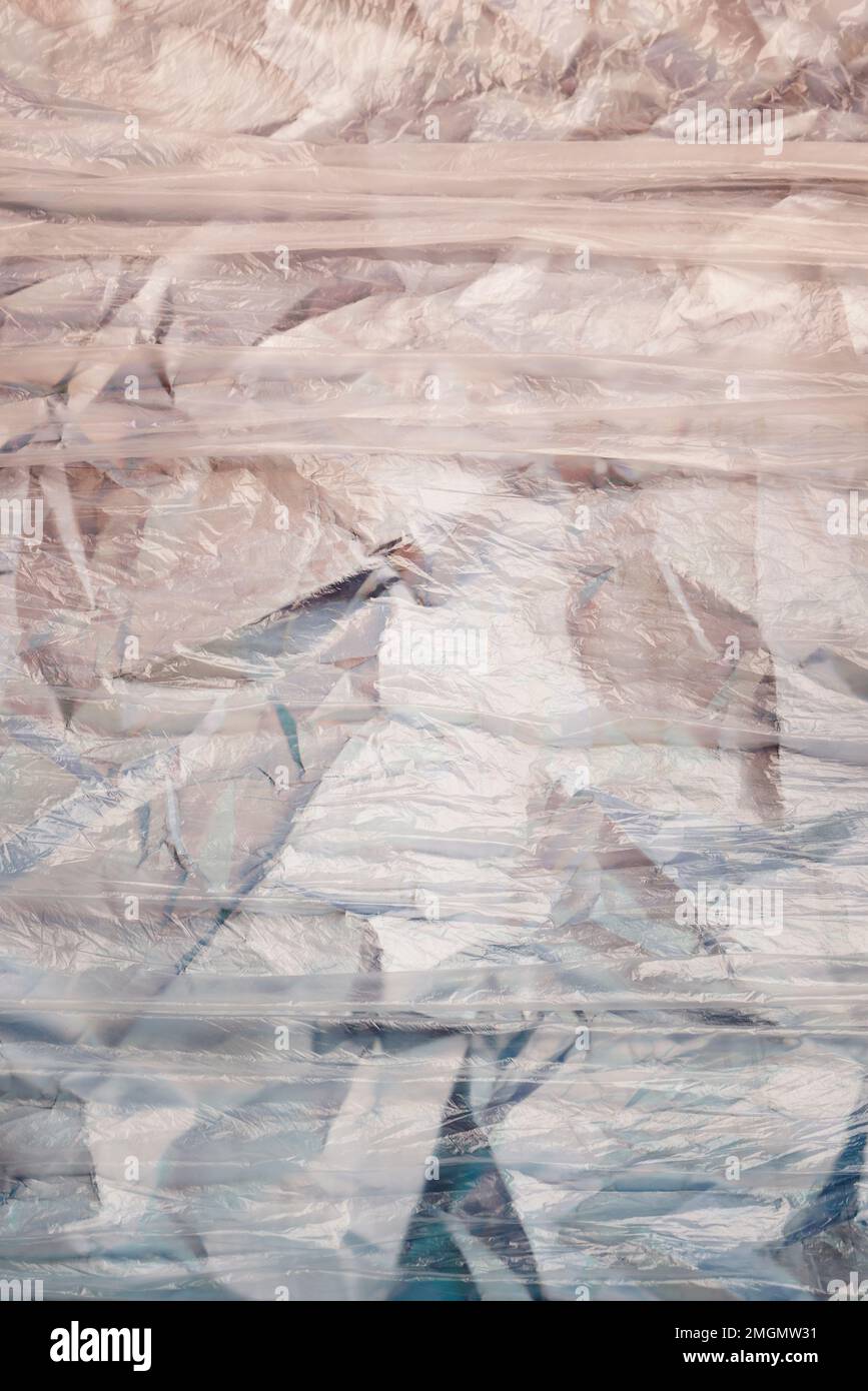 cellophane on metallic crumpled blue background. plastic textures ...