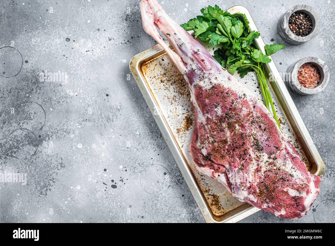 Marinated whole mutton leg, raw lamb meat with thyme, spices and olive ...