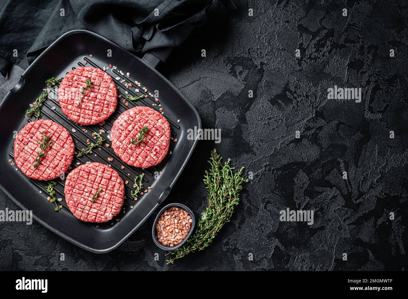 Raw Ground beef meat Burger steak cutlets in grill skillet ready for ...