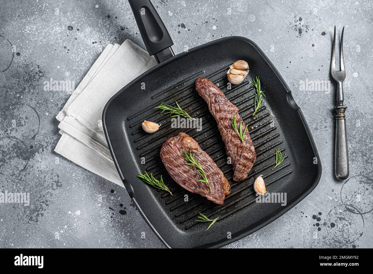 Roasted on a grill skillet Flank flap or Bavette beef meat steak with ...