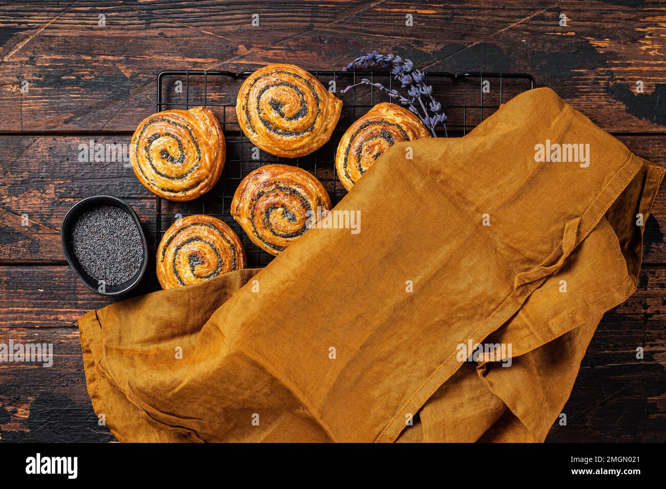 Sweet roll poppy seed buns with lavender ready for cooking. Wooden ...
