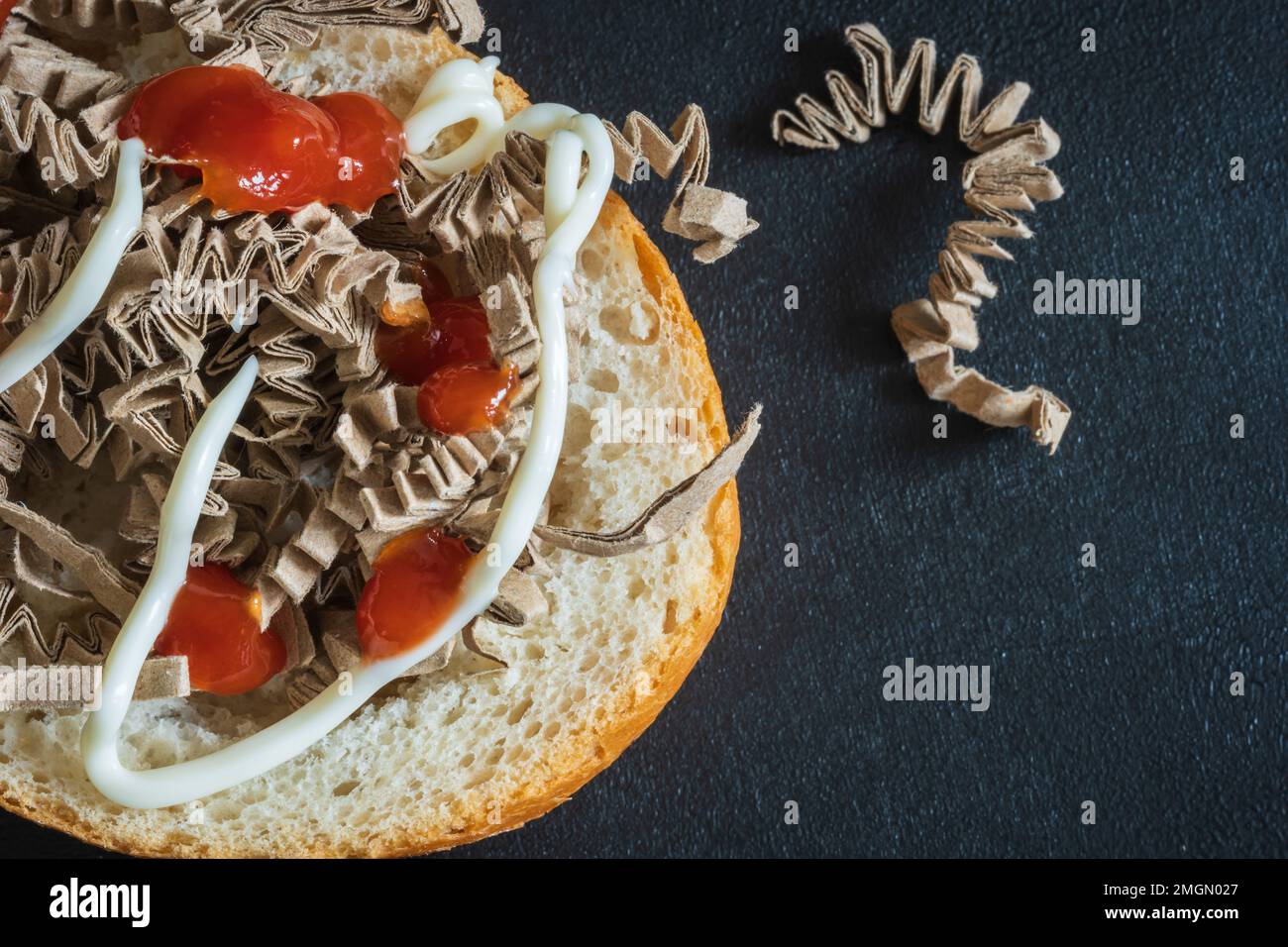 Burger filled with paper cardboard waste with juicy mayo and ketchup ...