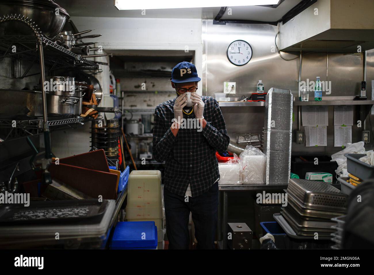 Peck's Food general manager Kyle Dollinger adjusts his protective face ...