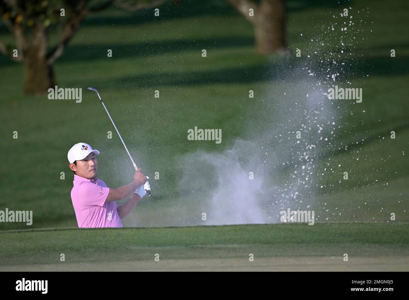Sung Kang, of South Korea, watches his shot from a bunker onto the 15th ...