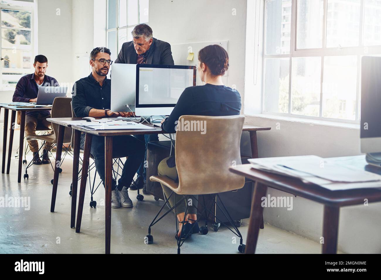 Training, coaching and business people with computer in office ...