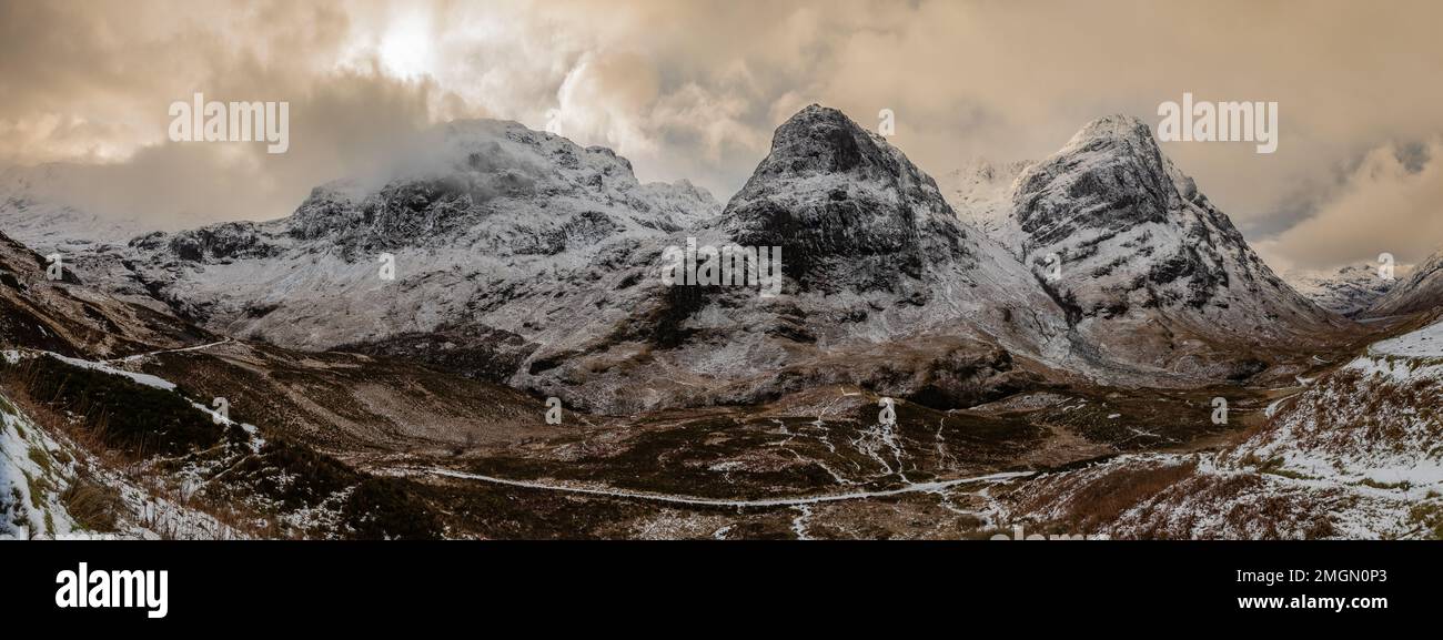 An aerial view of snow covered mountain landscape during sunset Stock ...