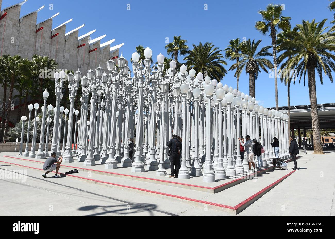 Visitors take pictures around artist Chris Burden's "Urban Light ...