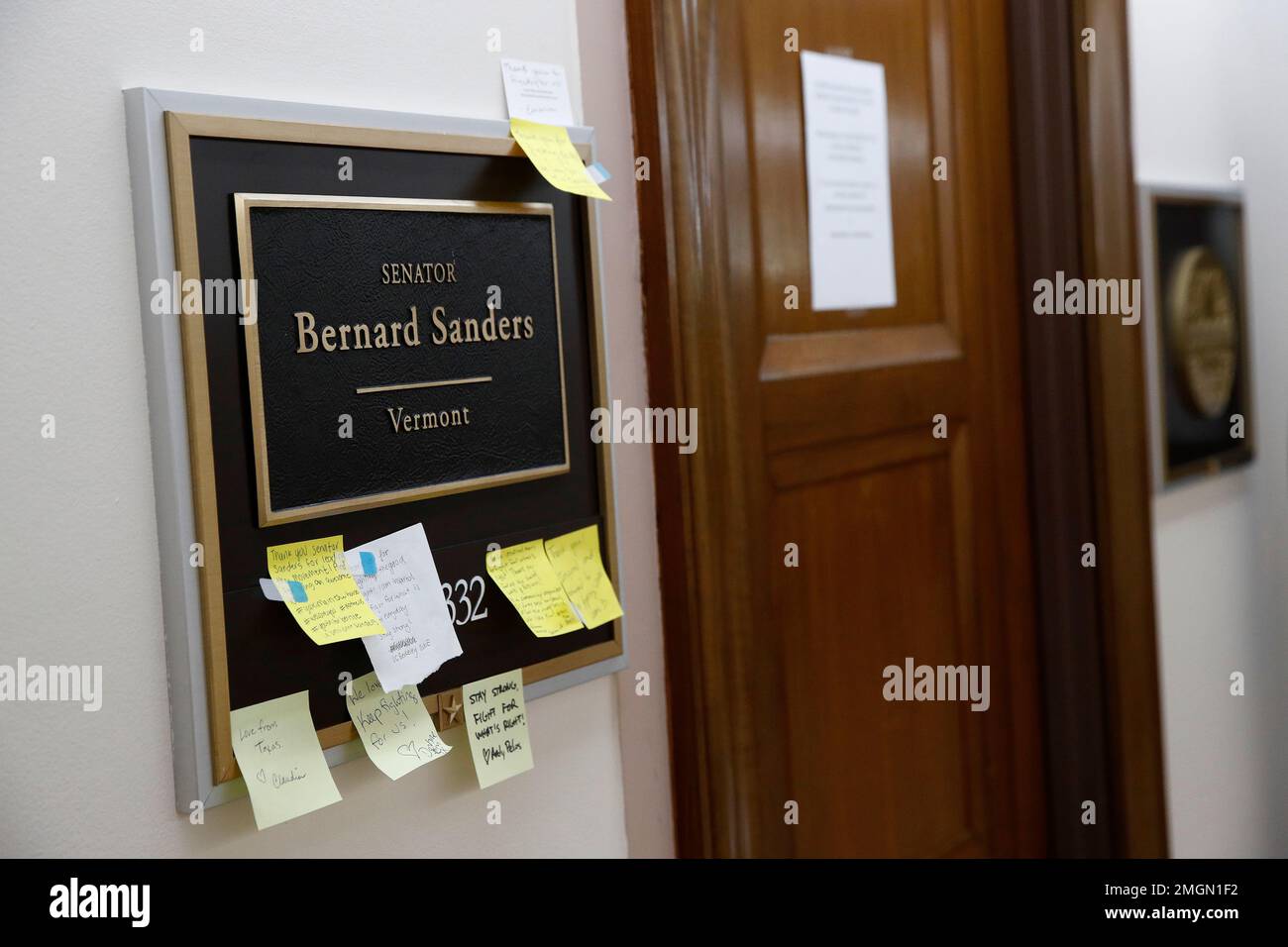 Notes of support are posted on a sign outside the Senate office of ...