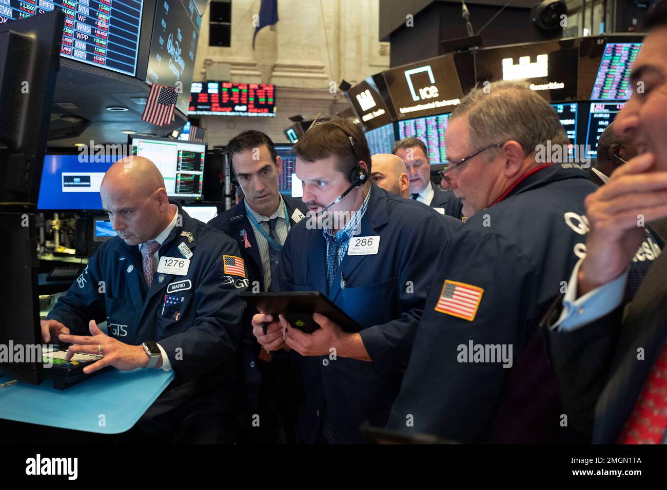 Traders at the New York Stock Exchange work as the market closes ...