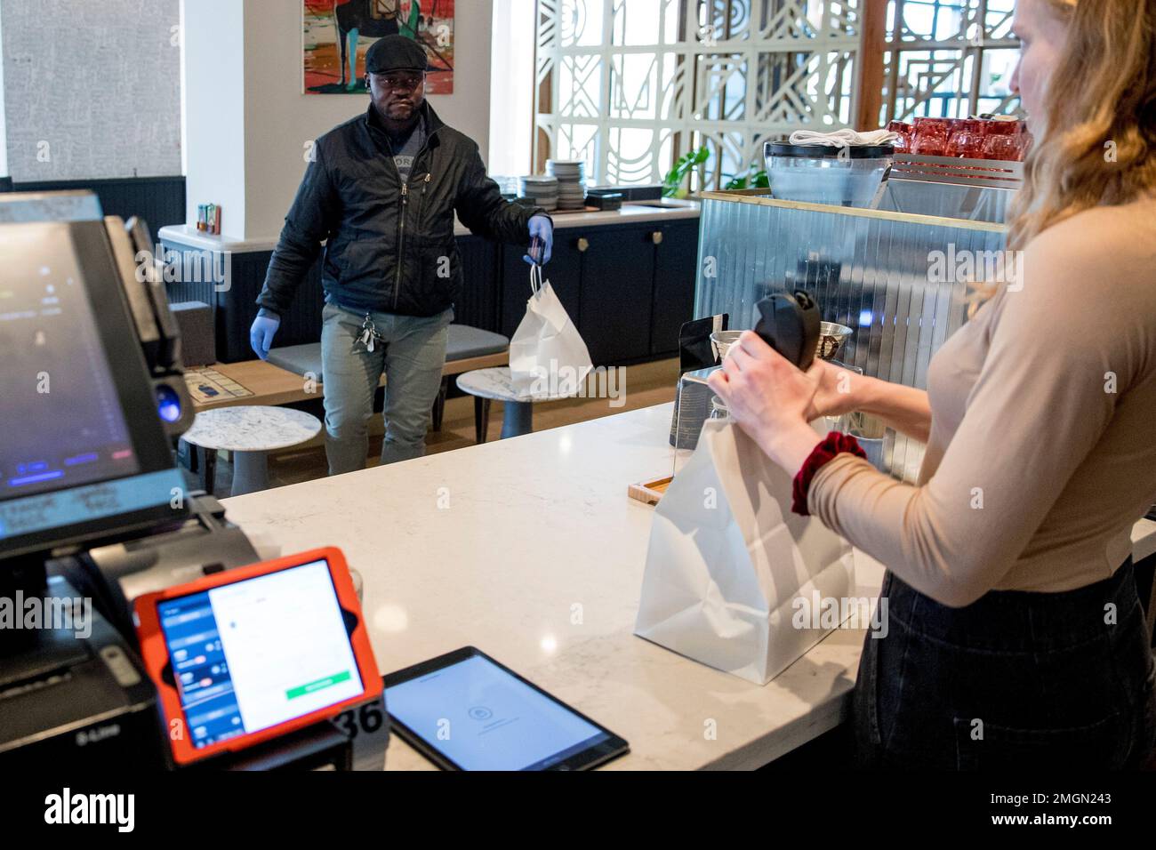 A man picks up food for him and his wife from Rebecca Buchanan at ABC ...