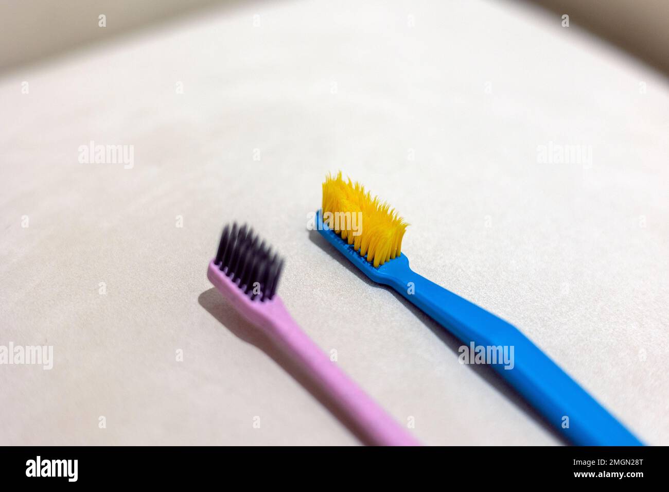 New toothbrush and old toothbrush in bathroom Stock Photo - Alamy