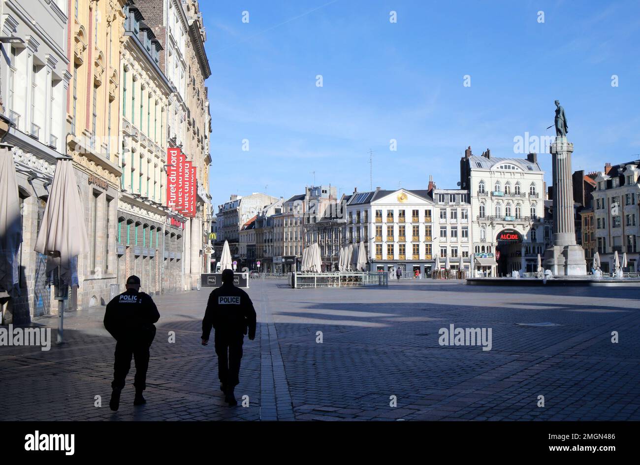 Police patrol a deserted main square, in Lille, northern France ...