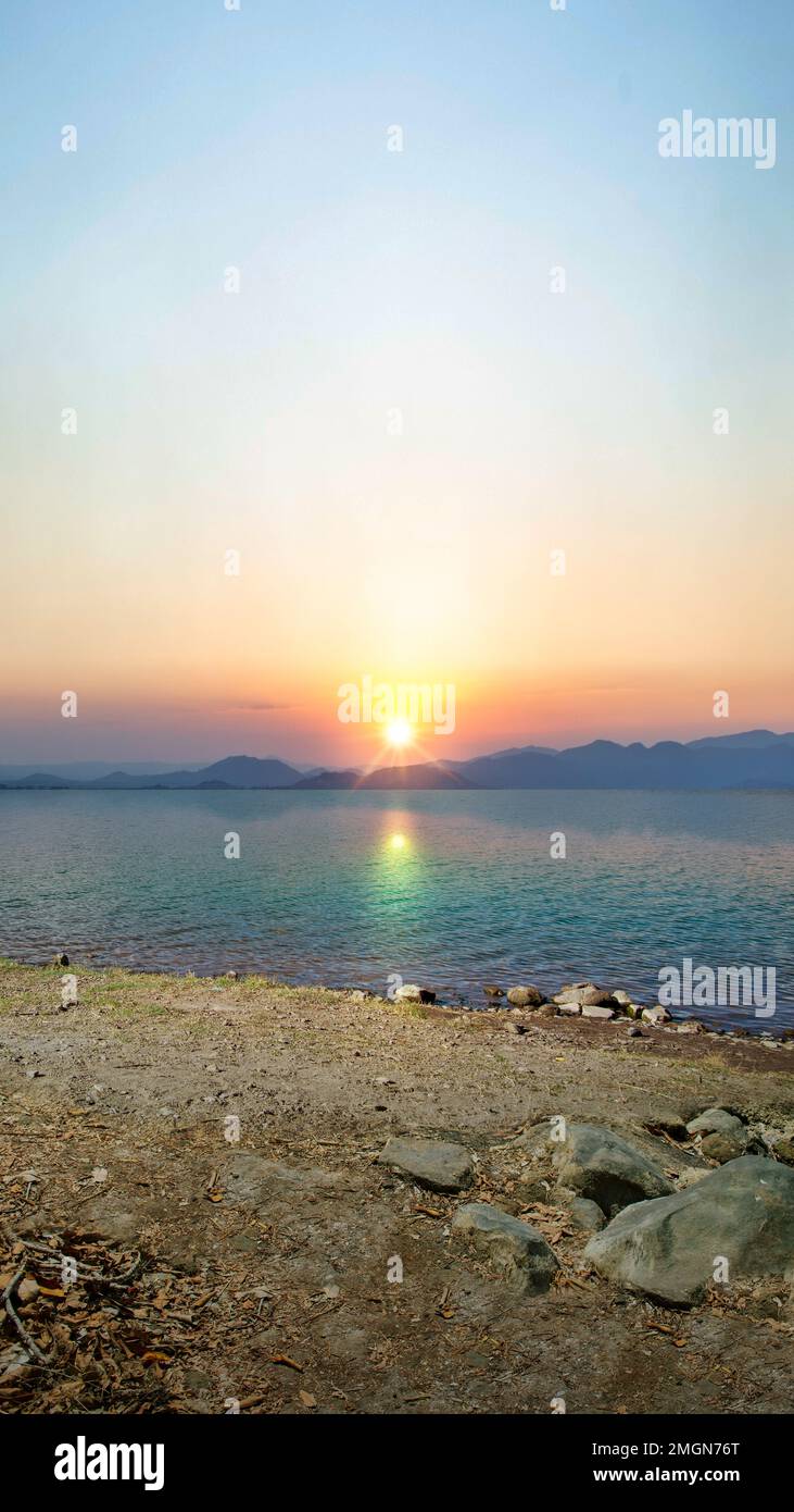The landscape of a lake with a sunset sky background Stock Photo - Alamy