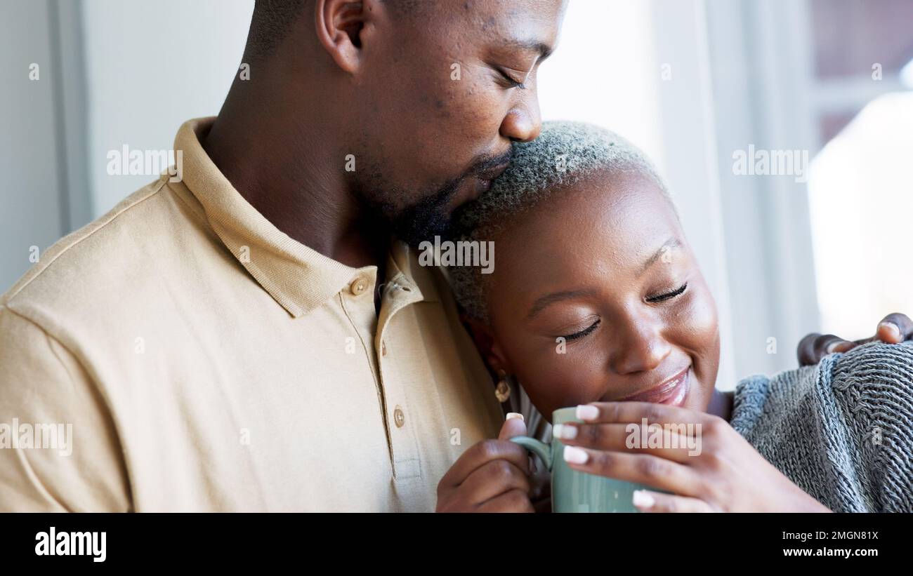 Relax, love and couple hug with coffee drink break at window to enjoy while they bond together ...