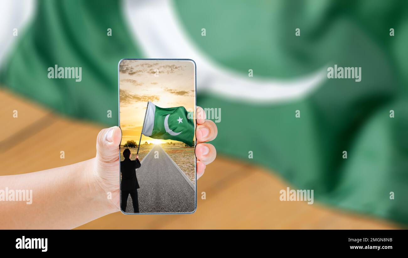 Rear view of Asian businessman holding Pakistan flag. Pakistan ...
