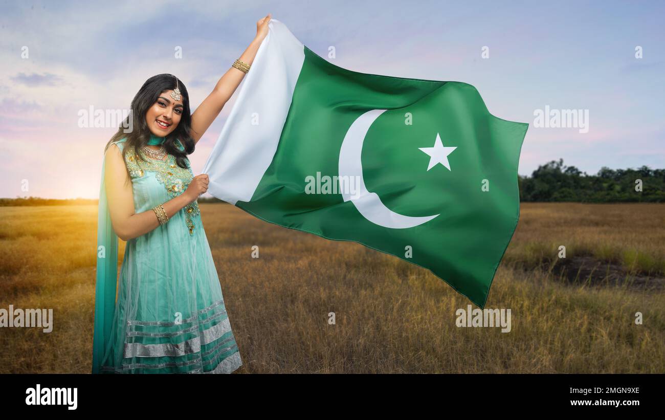 Asian woman holding Pakistan flag. Pakistan Resolution Day Stock Photo ...