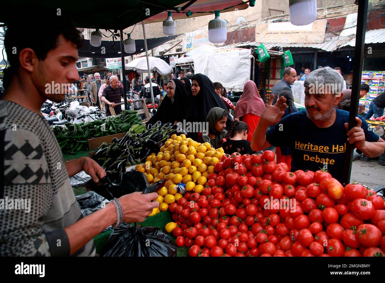 Iraqis buy groceries in downtown Baghdad, Iraq, Monday, March 16, 2020 ...